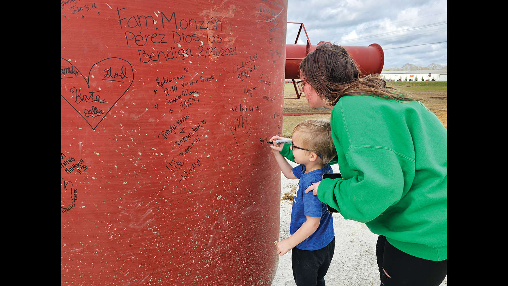 Making a mark: Everyone invited to sign inside base of 150-foot cross ...